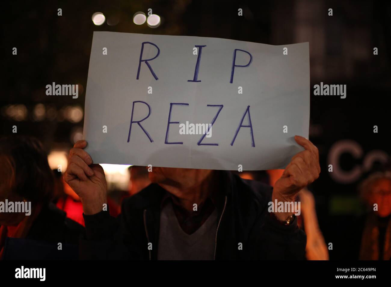 A sign saying, “RIP Reza” is held at the candle lit vigil outside ... A sign saying, “RIP Reza” is held at the candle lit vigil outside ...