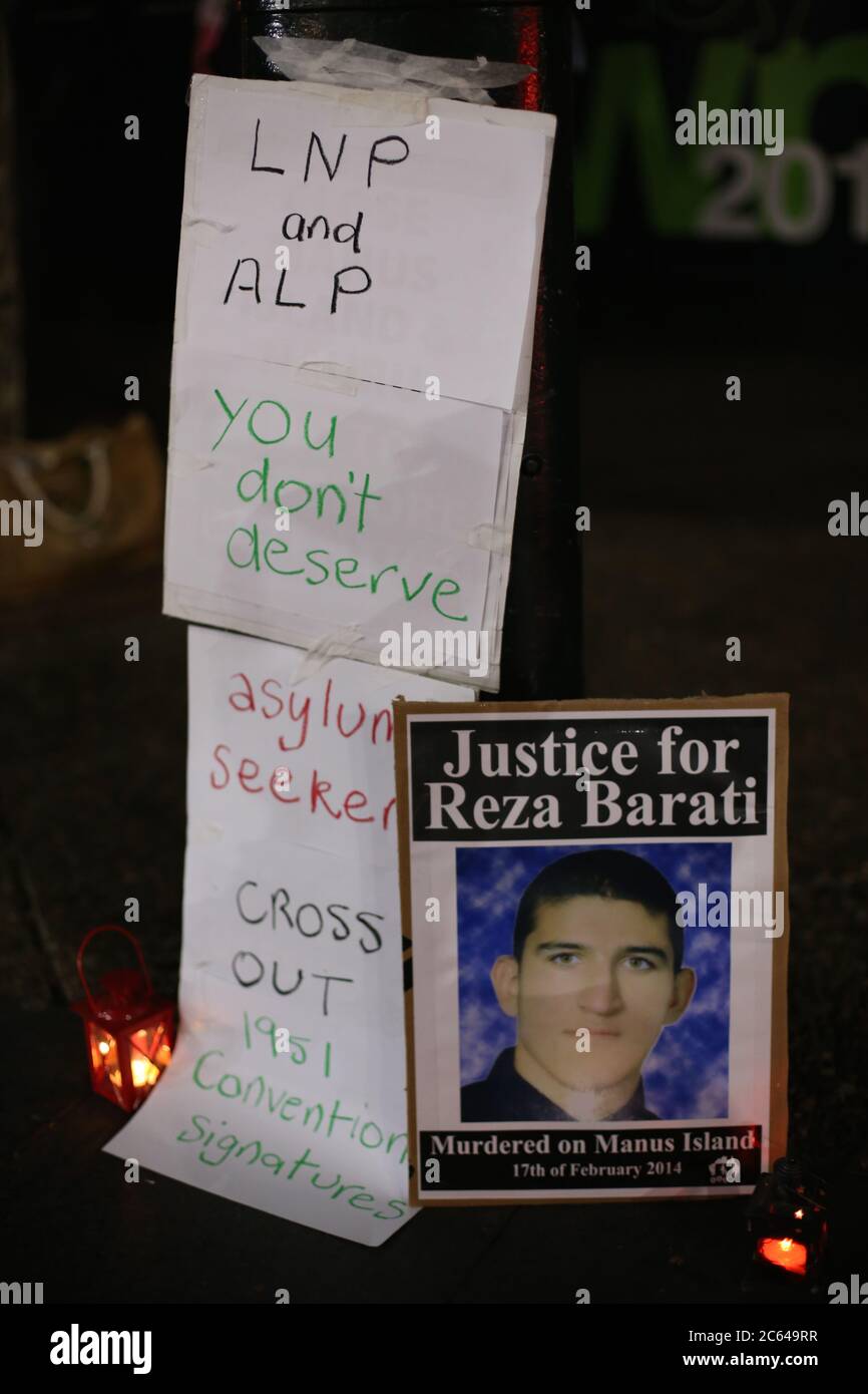 A makeshift shrine is made with a picture of Reza Barati and candles in ...