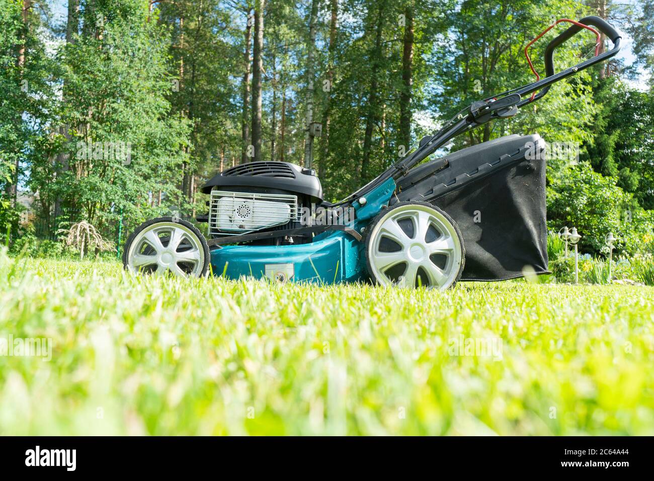 Mowing lawns. Lawn mower on green grass. Mower grass equipment. Mowing ...