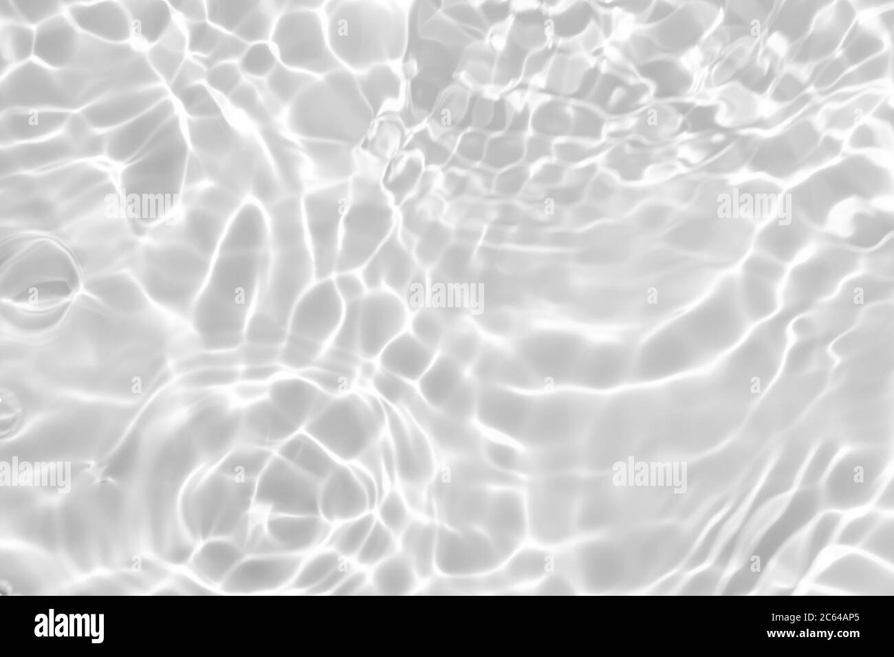 Closeup of desaturated transparent clear calm water surface texture ...