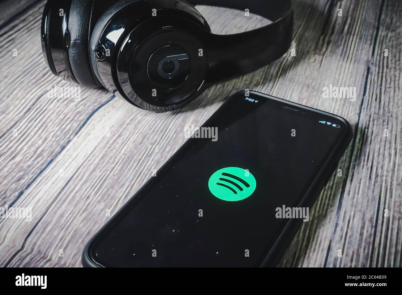 An iphone 11 screen showing spotify icon with beats earphone, perfect ...