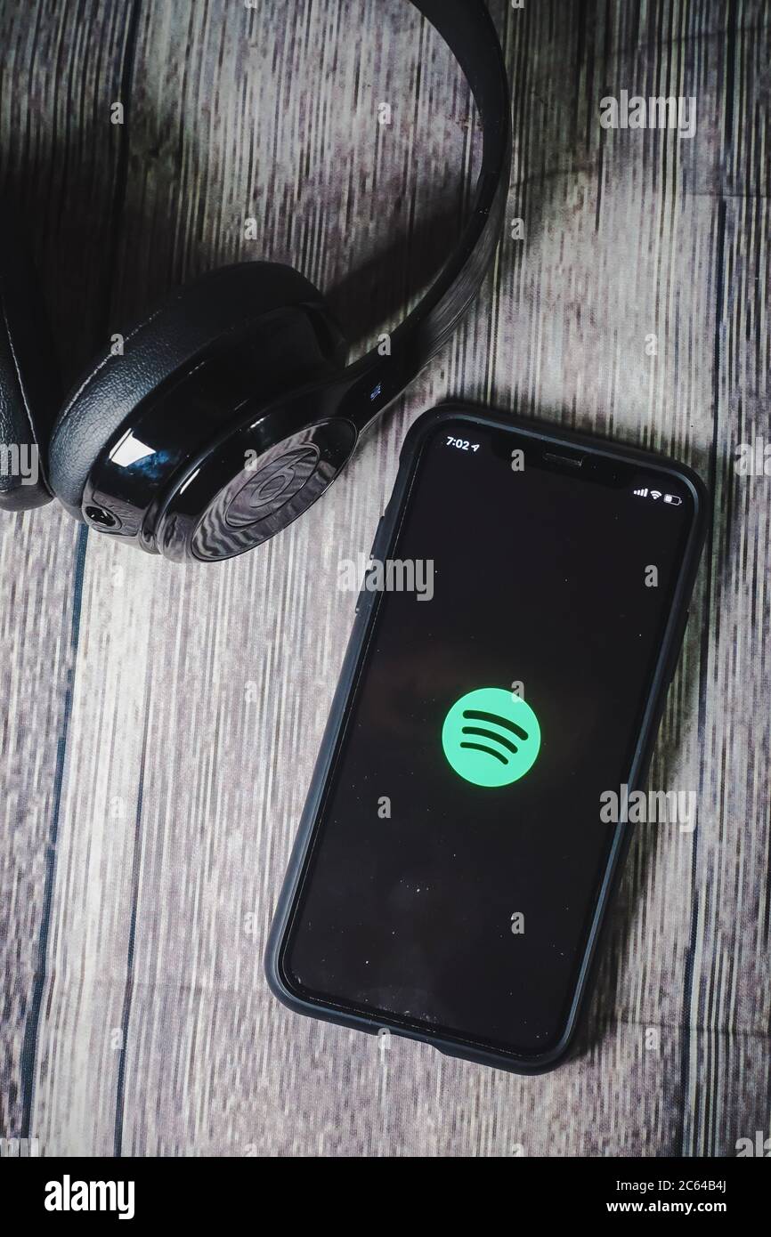 An iphone 11 screen showing spotify icon with beats earphone, perfect ...