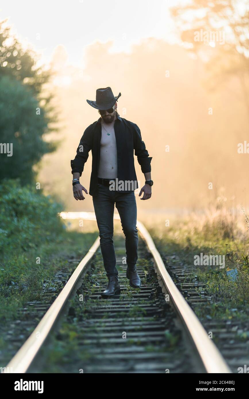cowboy walking the railroad tracks Stock Photo - Alamy