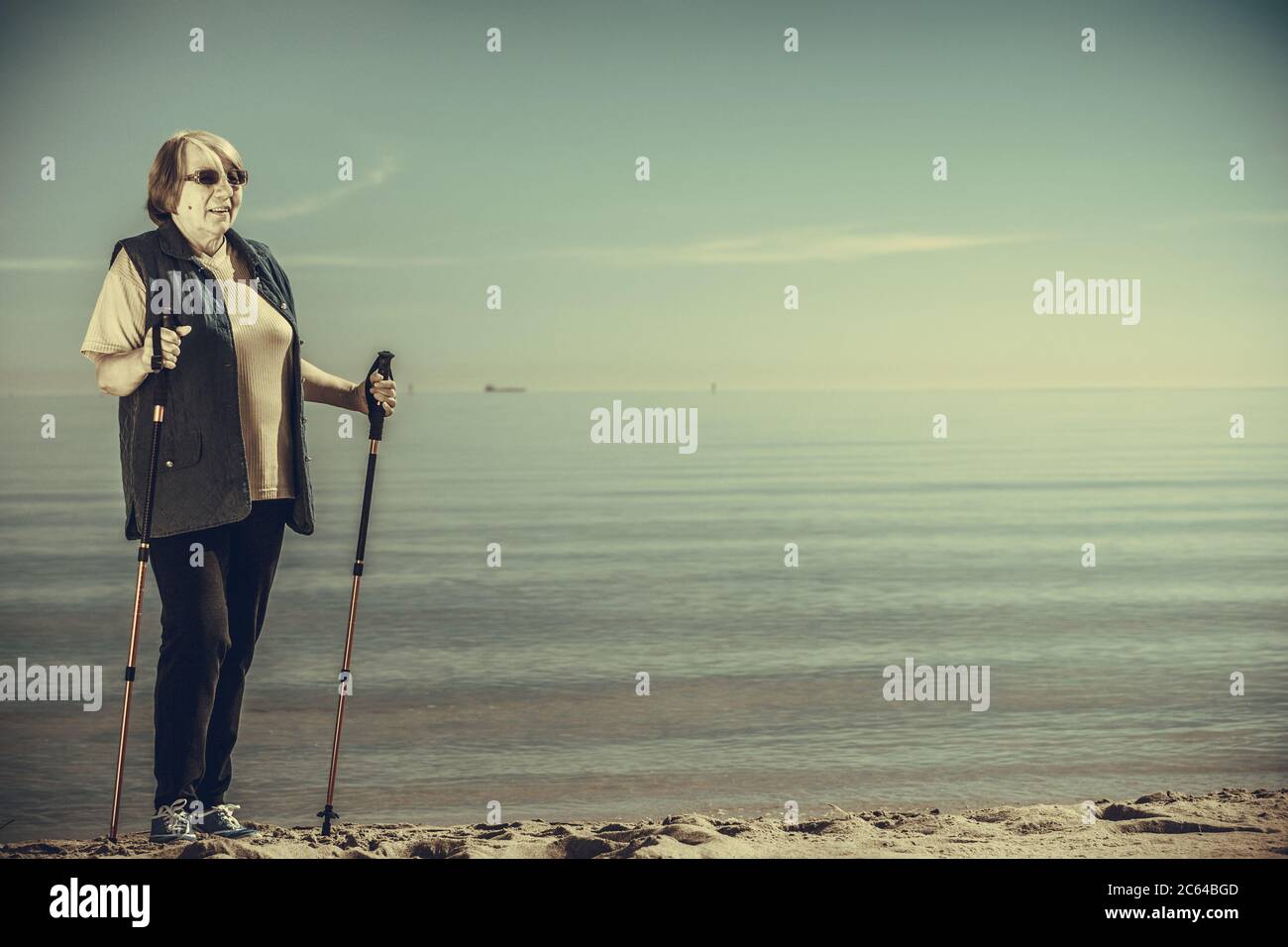 Healthy lifestyle in old age. Senior woman practicing nordic walking on ...