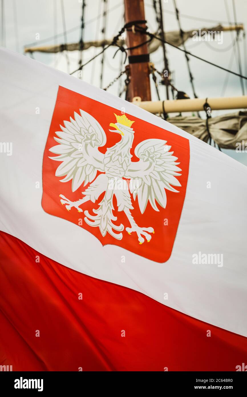 Closeup of polish national flag with eagle emblem on ship in marine ...
