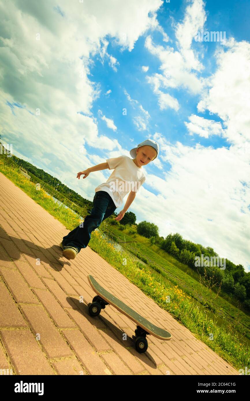 Active childhood. Little man skateboarding. Skater boy child kid with ...