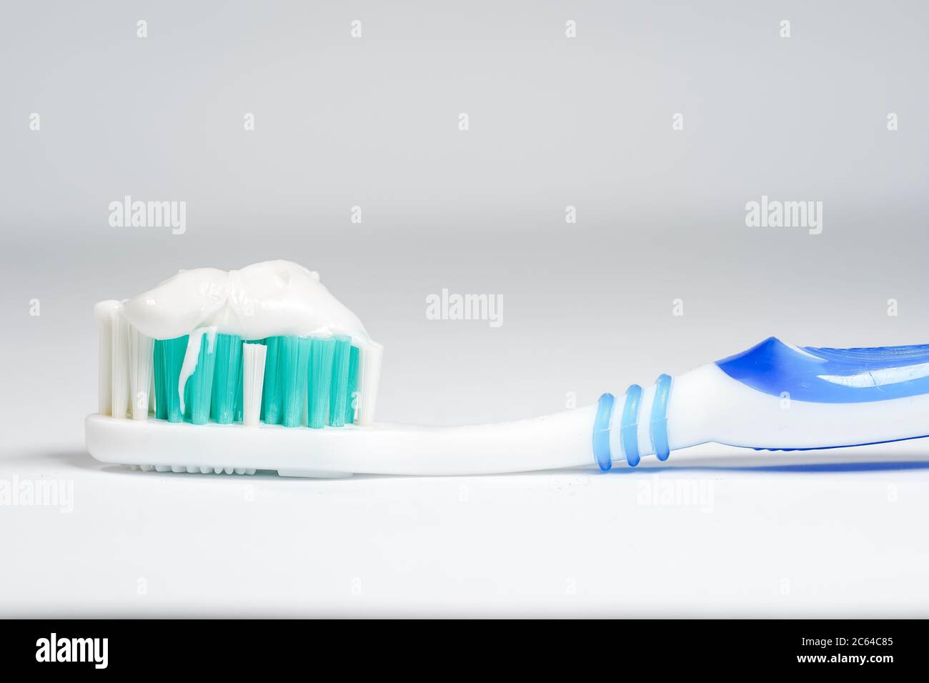 Toothbrush with toothpaste isolated on white background Stock Photo - Alamy