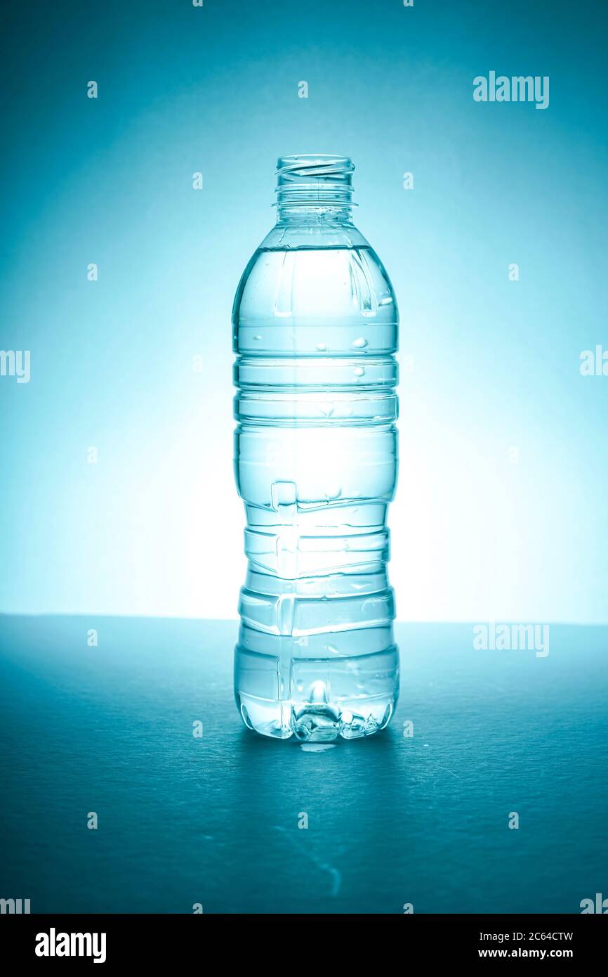 Bottle fills with water, isolated Stock Photo - Alamy