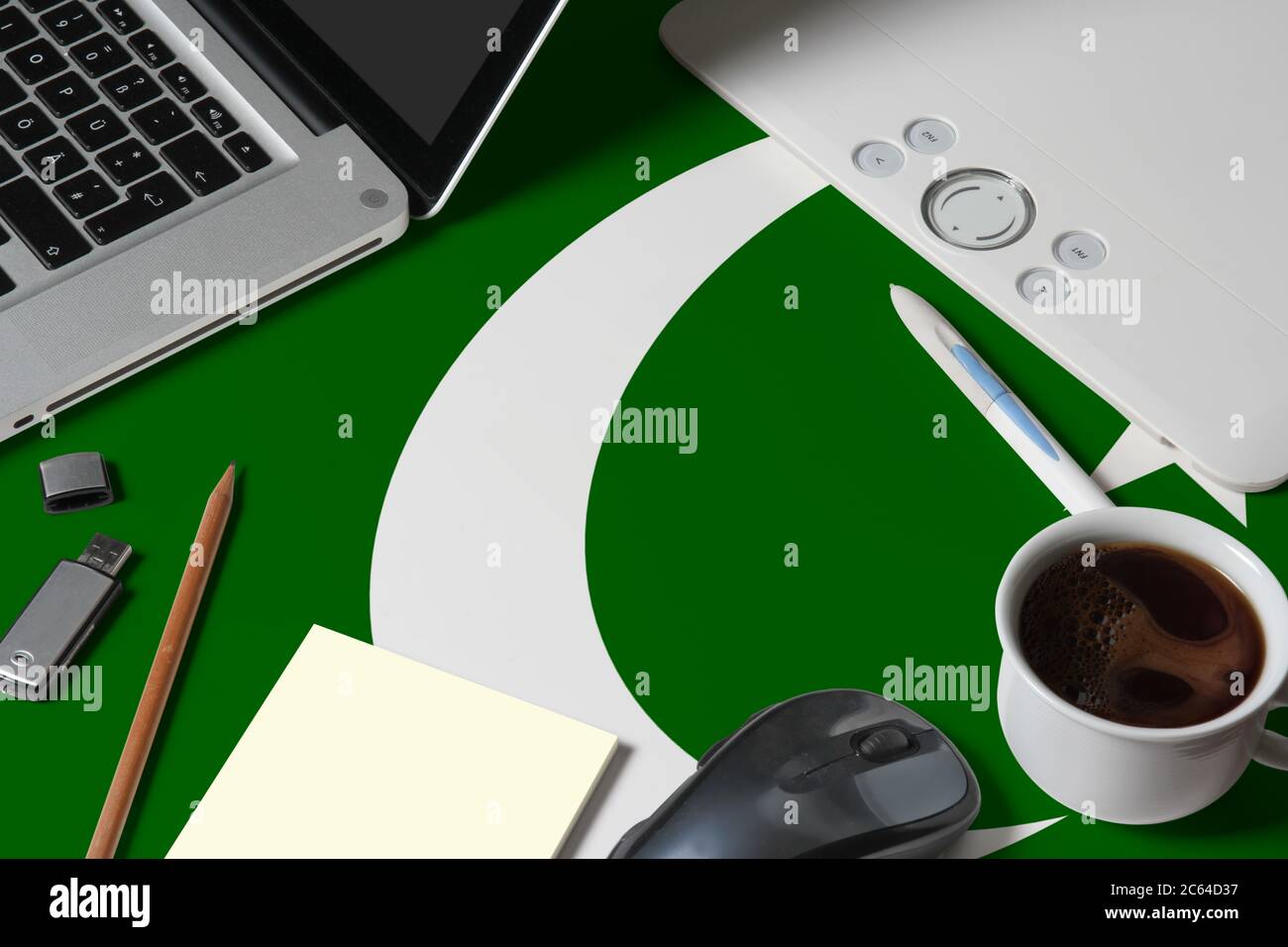 Pakistan national flag on top view work space of creative designer with ...