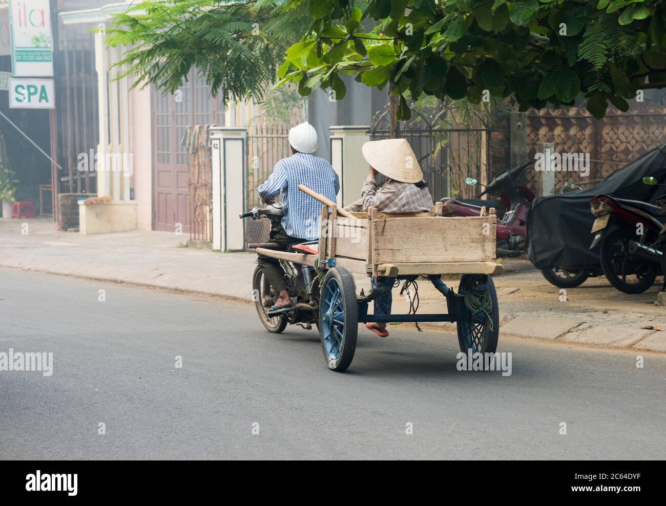 Two local Vietnamese people travelling on traditional Vietnamese ...