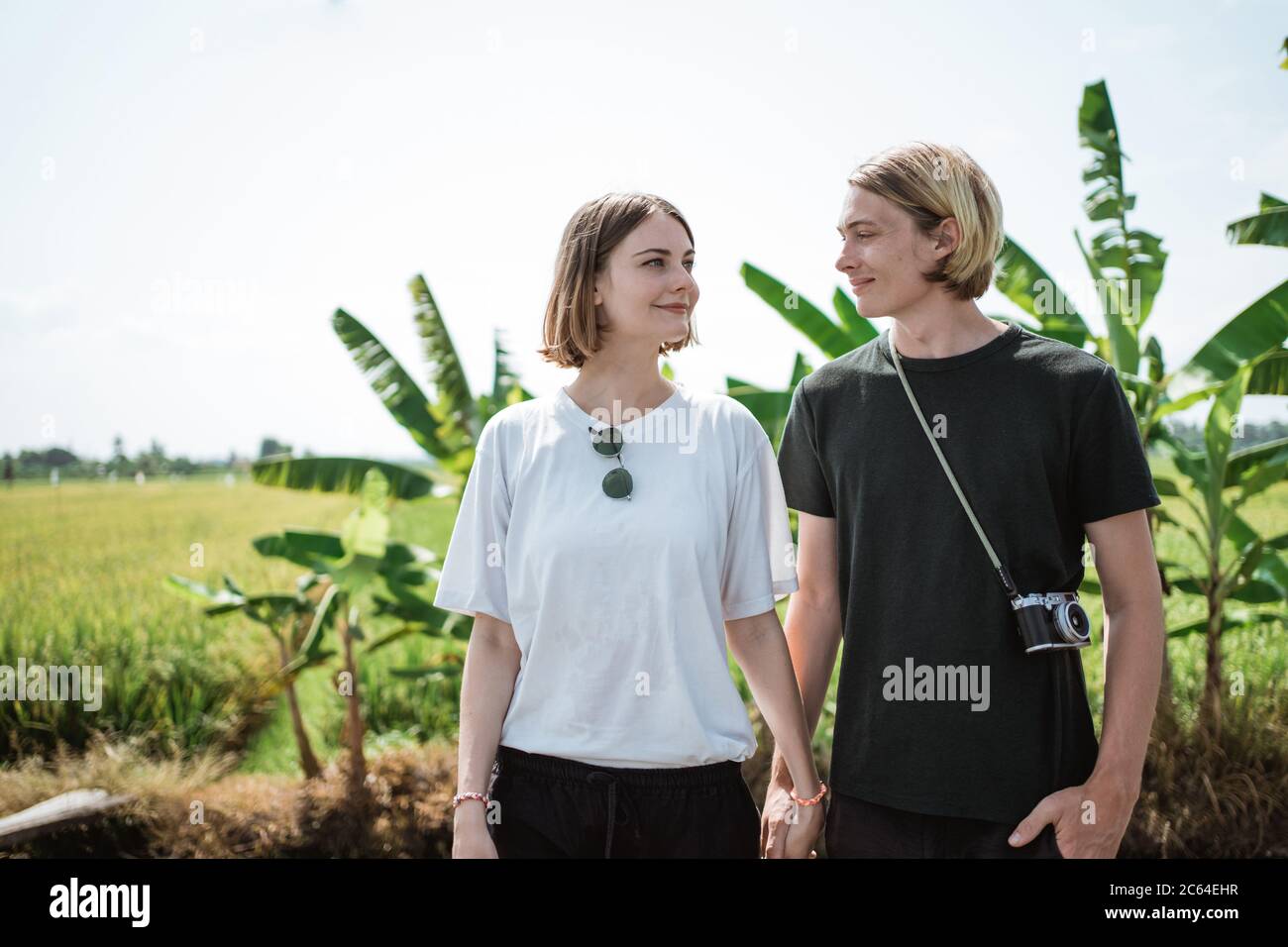 A couple look at each other on the edge of the rice field Stock Photo ...