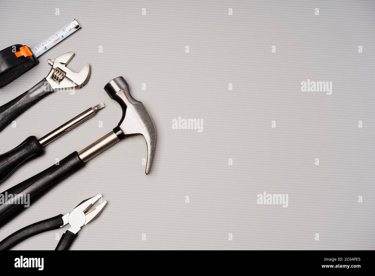 Flat lay composition of a set of tools, including hammer, pliers ...