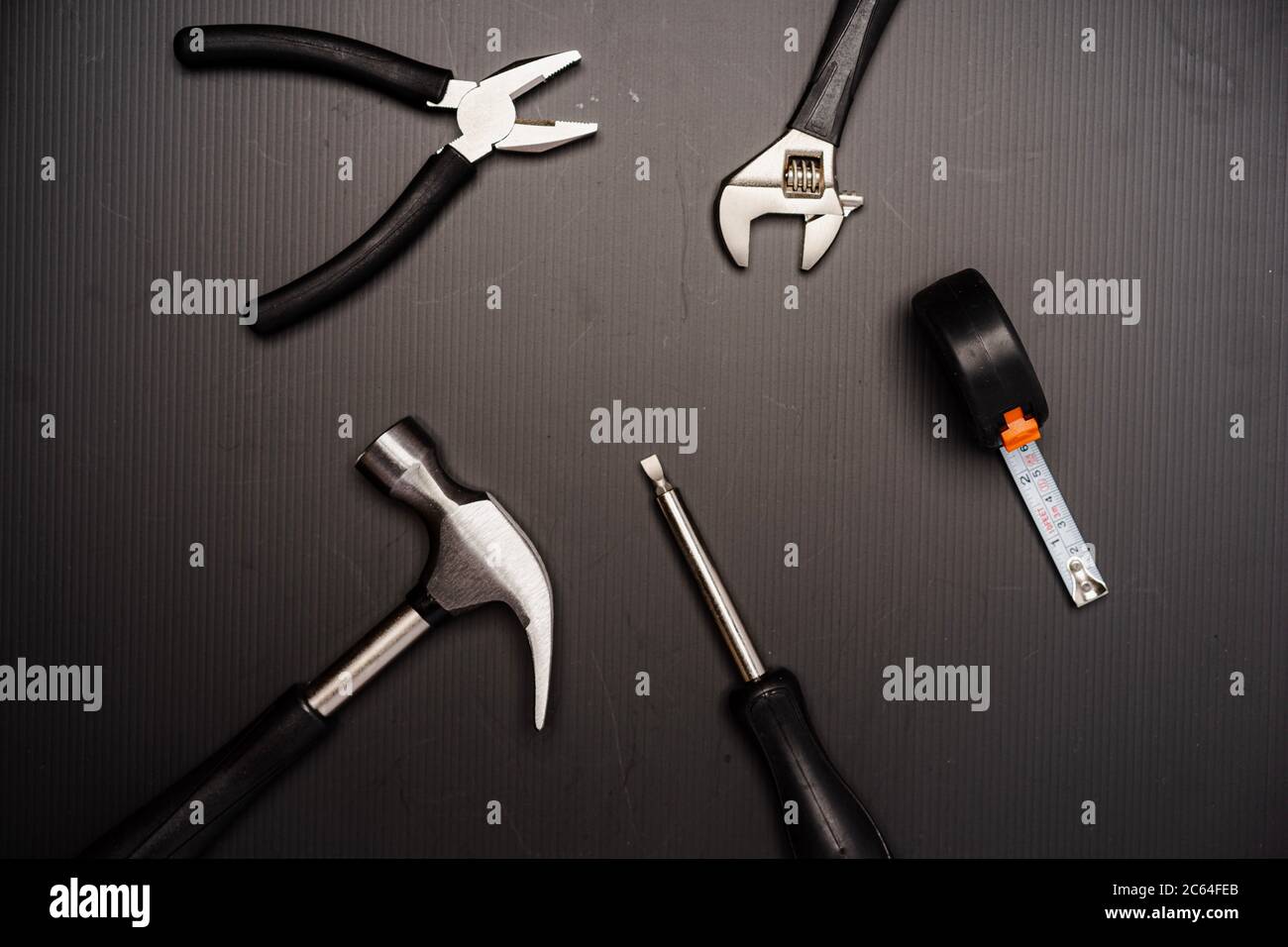Flat lay composition of a set of tools, including hammer, pliers ...
