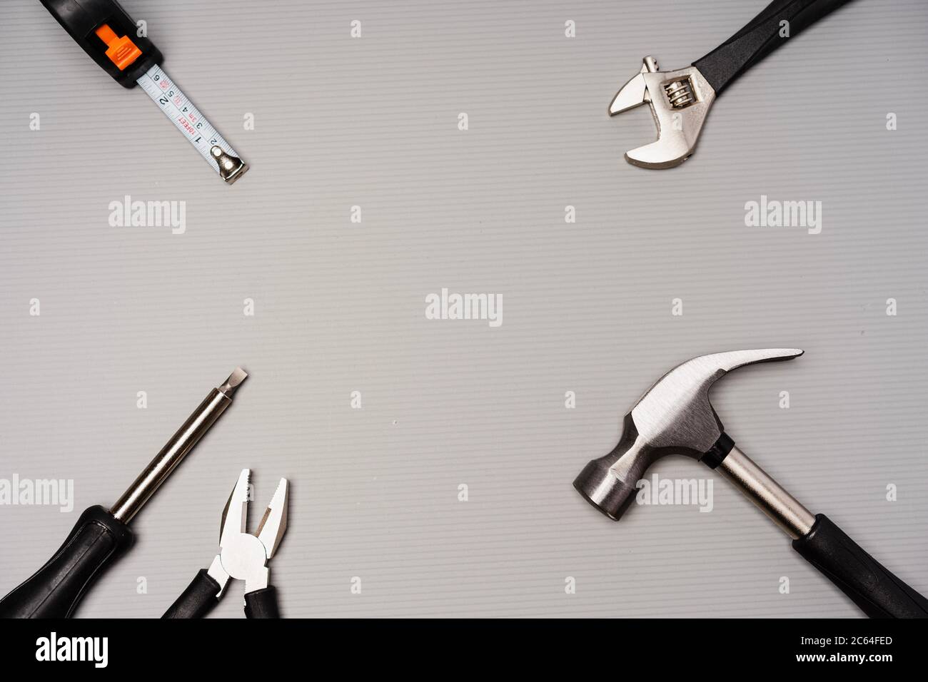 Flat lay composition of a set of tools, including hammer, pliers ...