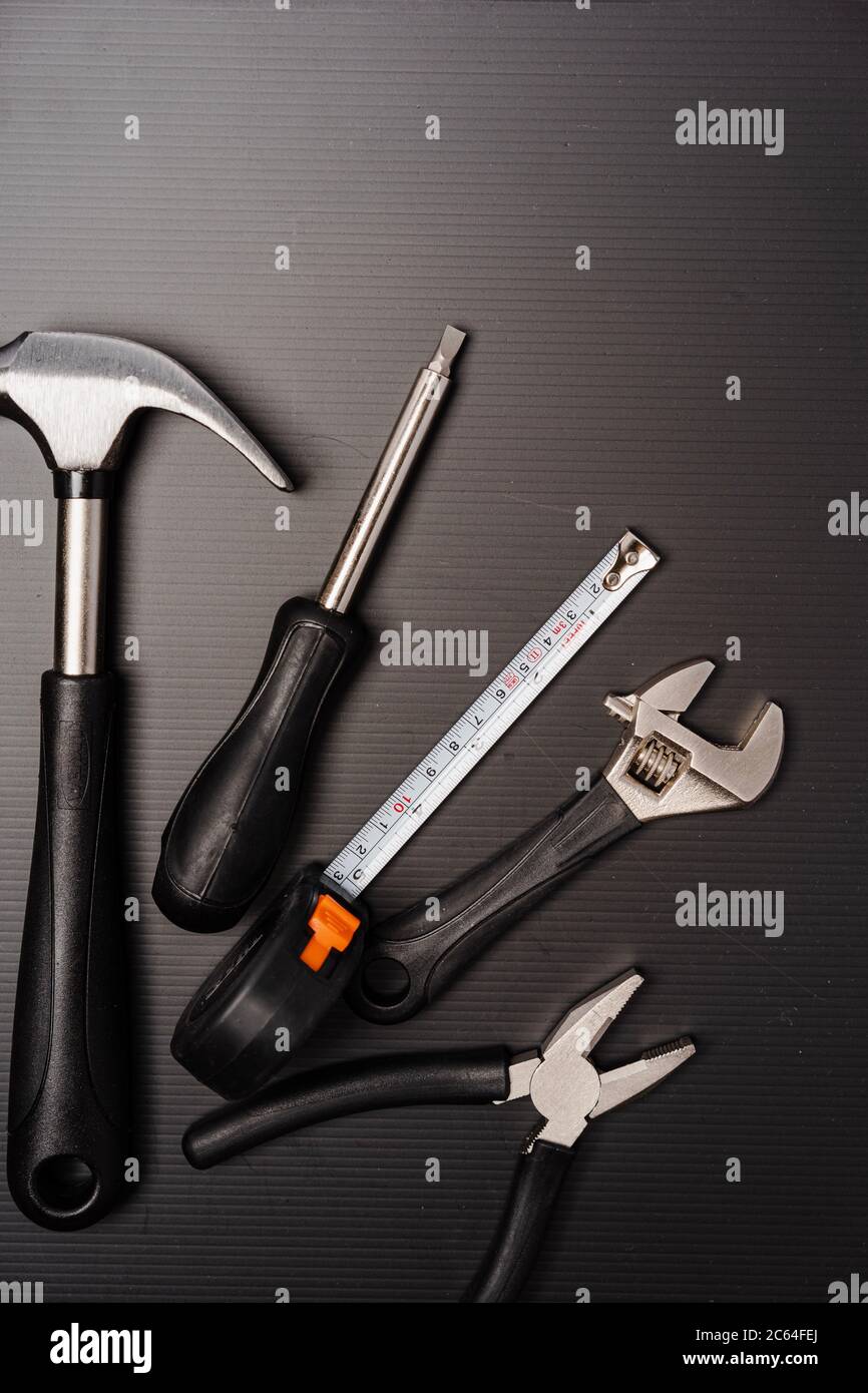Flat lay composition of a set of tools, including hammer, pliers ...