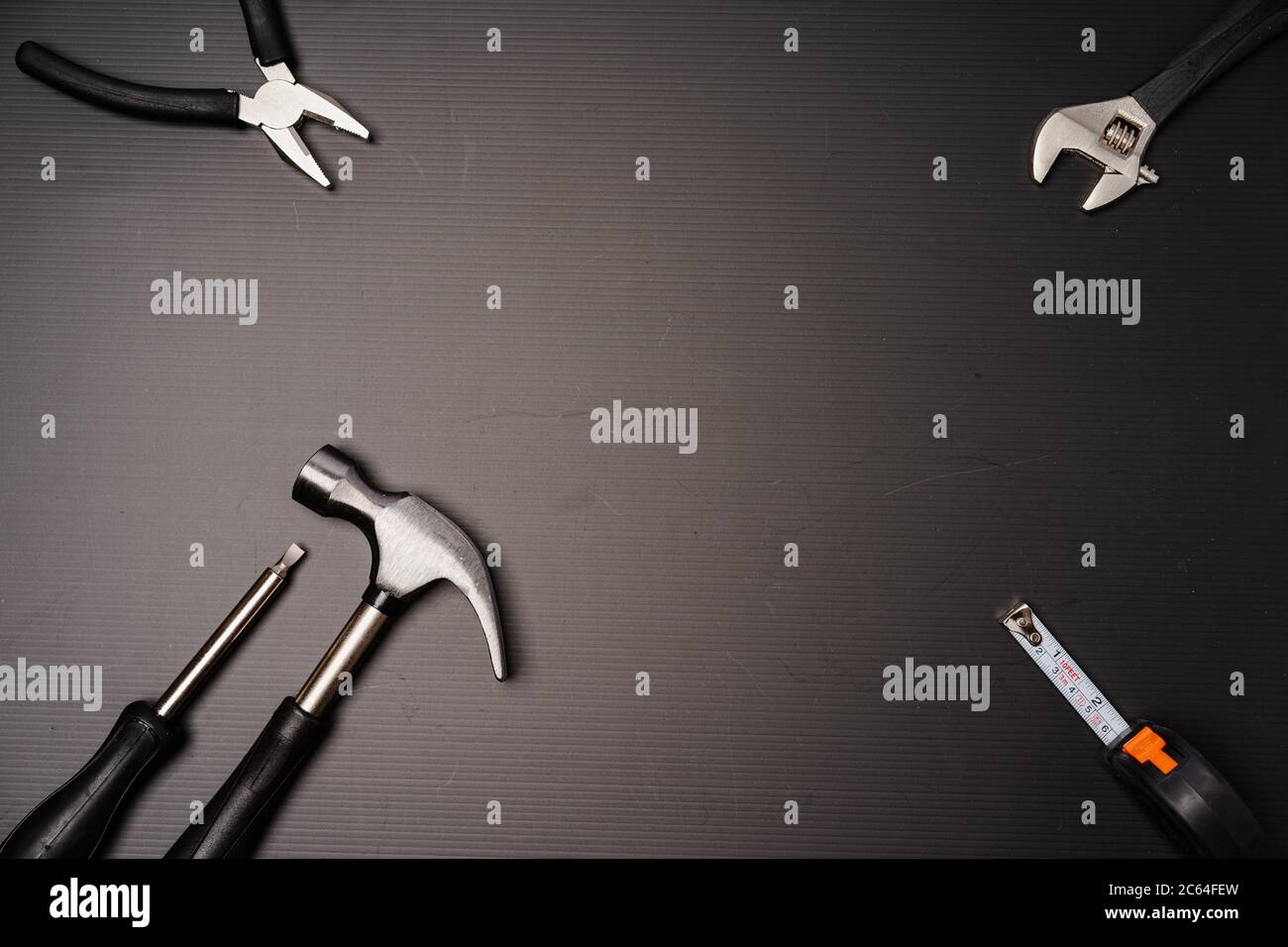 Flat lay composition of a set of tools, including hammer, pliers ...