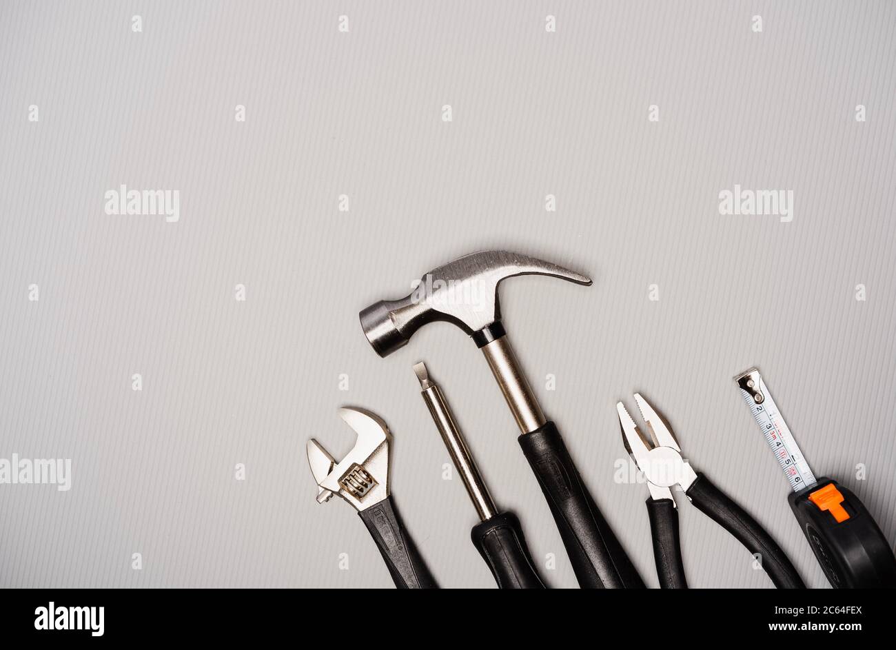 Flat lay composition of a set of tools, including hammer, pliers ...