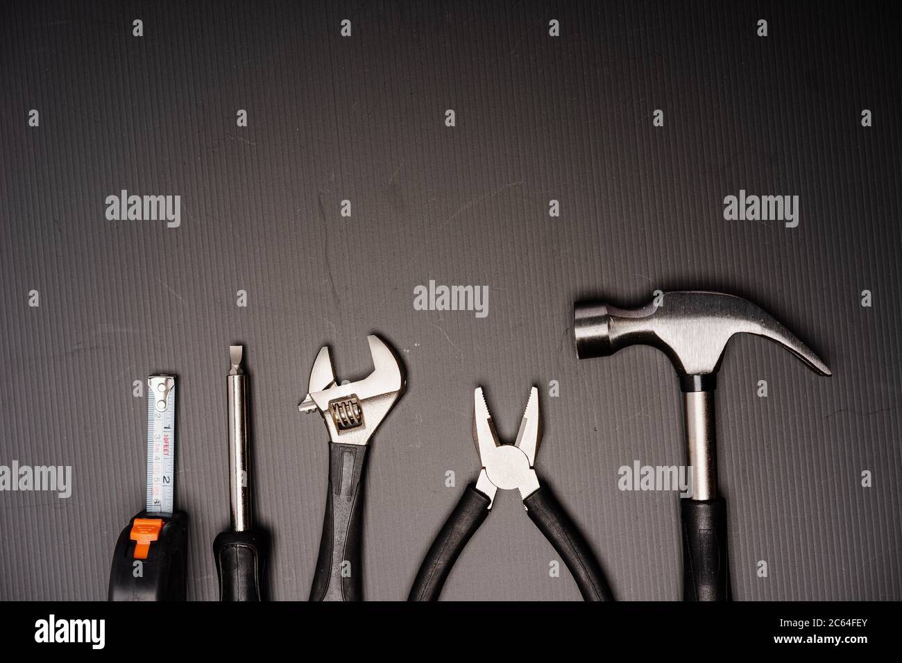 Flat lay composition of a set of tools, including hammer, pliers ...