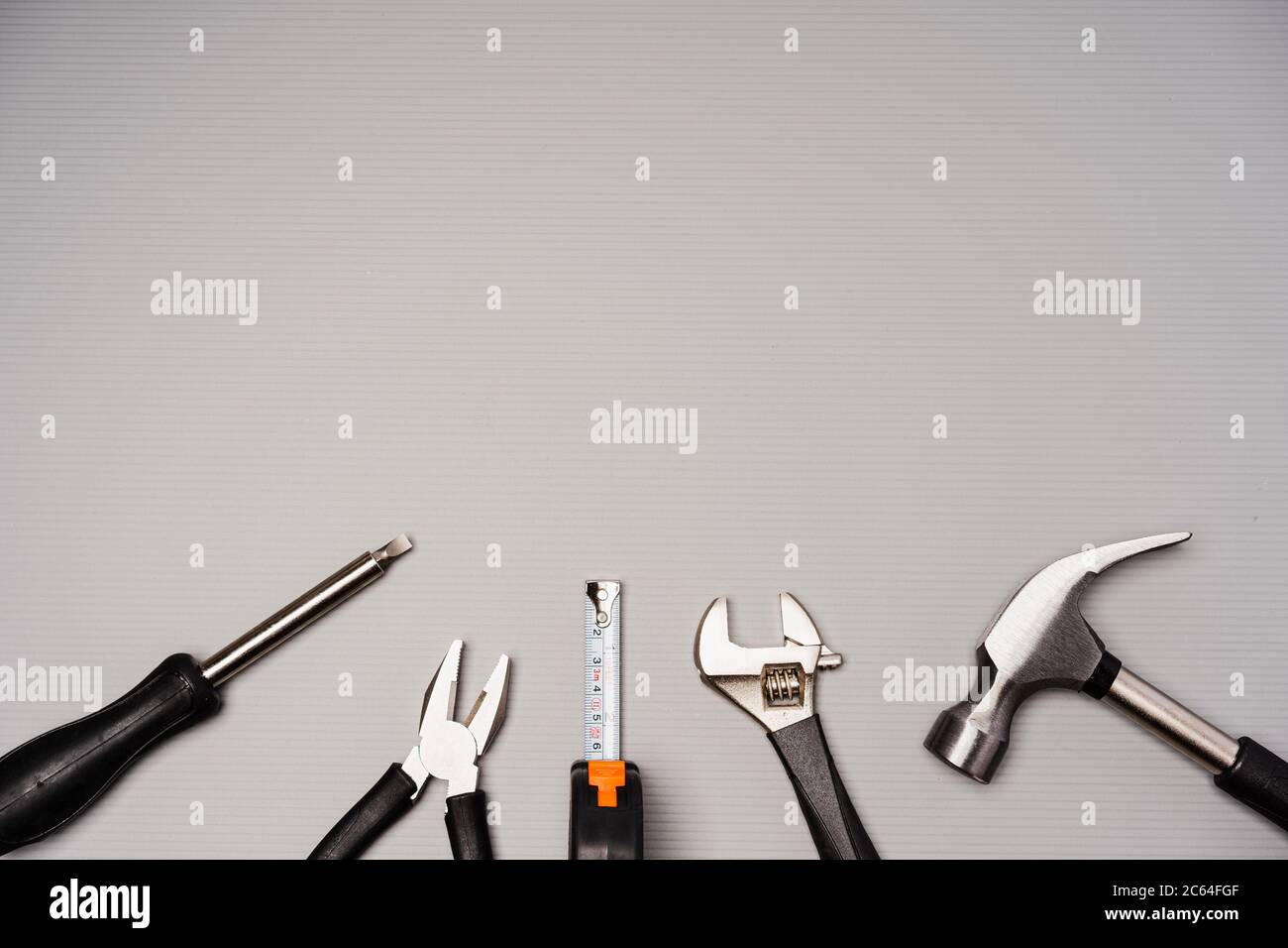 Flat lay composition of a set of tools, including hammer, pliers ...