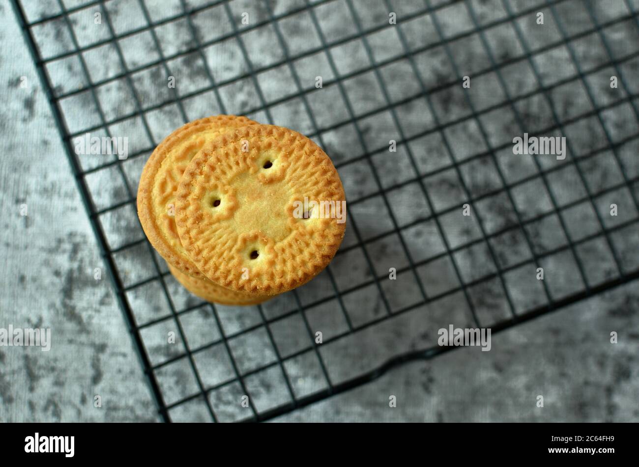 A row of biscuits with coconut chips on a cooling rack Stock Photo - Alamy
