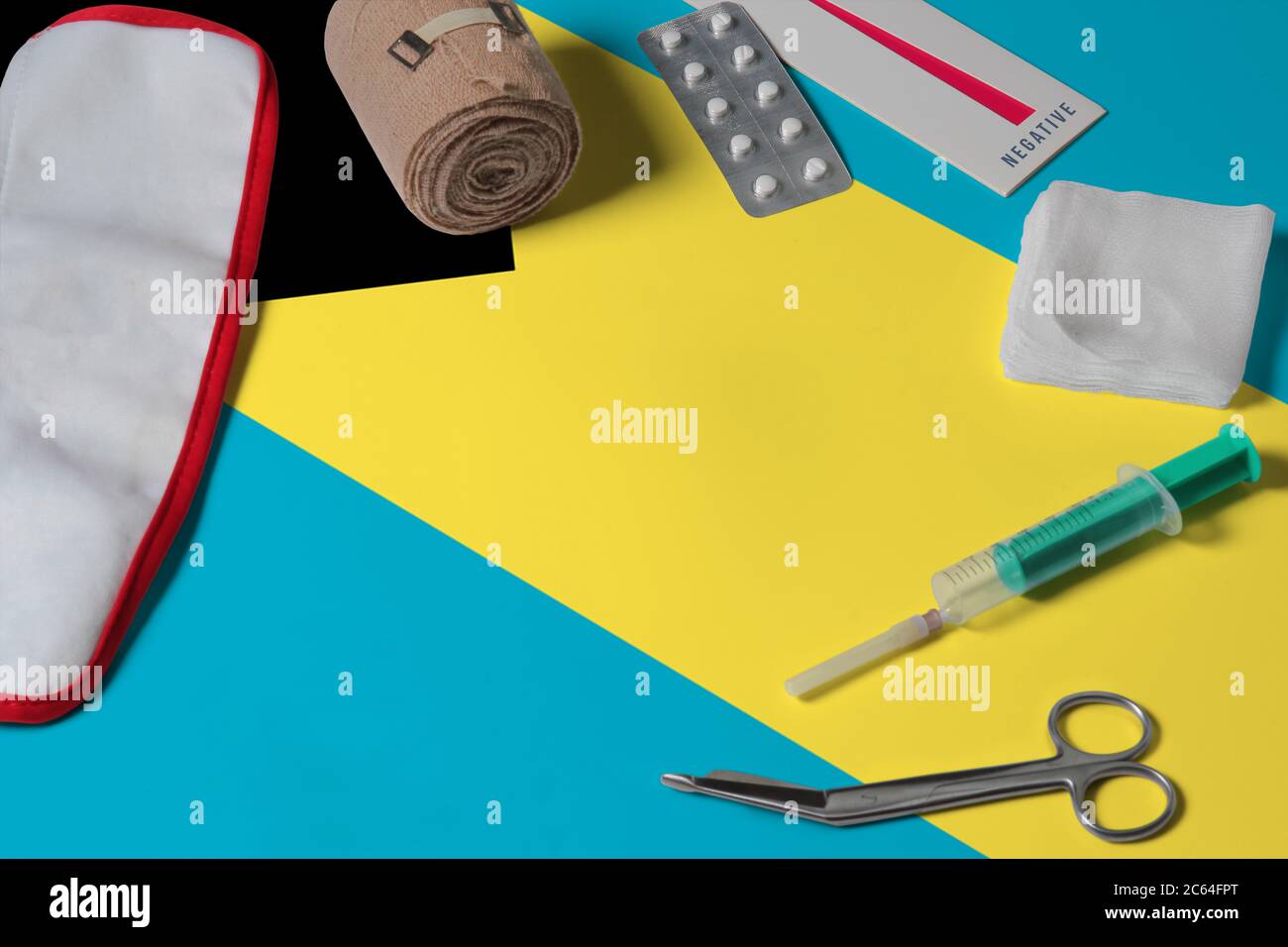 Bahamas flag with first aid medical kit on wooden table background ...