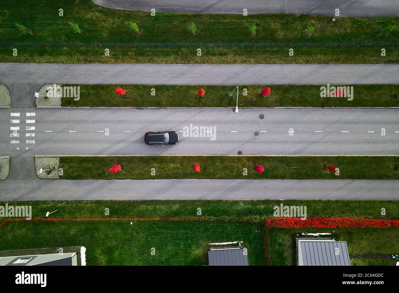 Aerial view of city street with car. Looking straight down with a ...