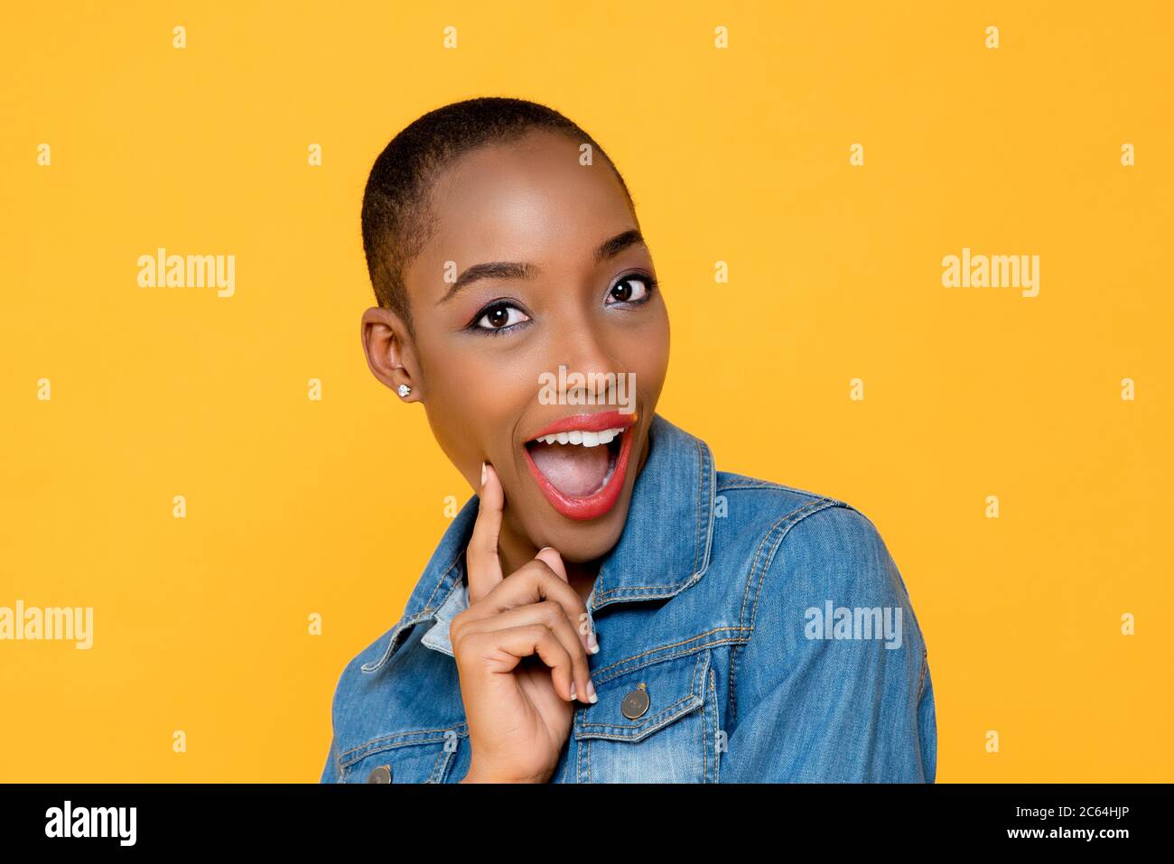 Fun close up portrait of smiling young African American woman pointing ...