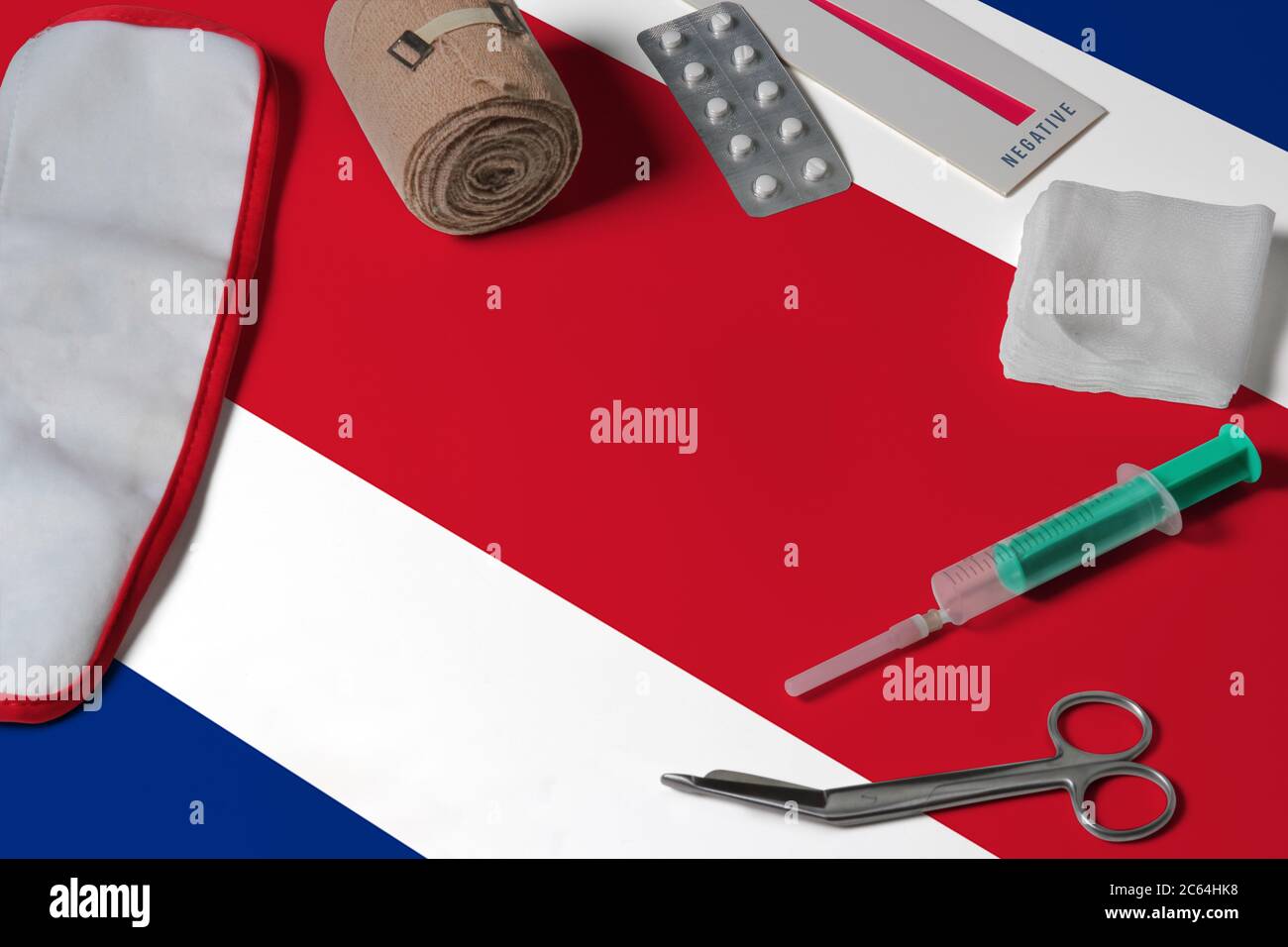 Costa Rica flag with first aid medical kit on wooden table background ...