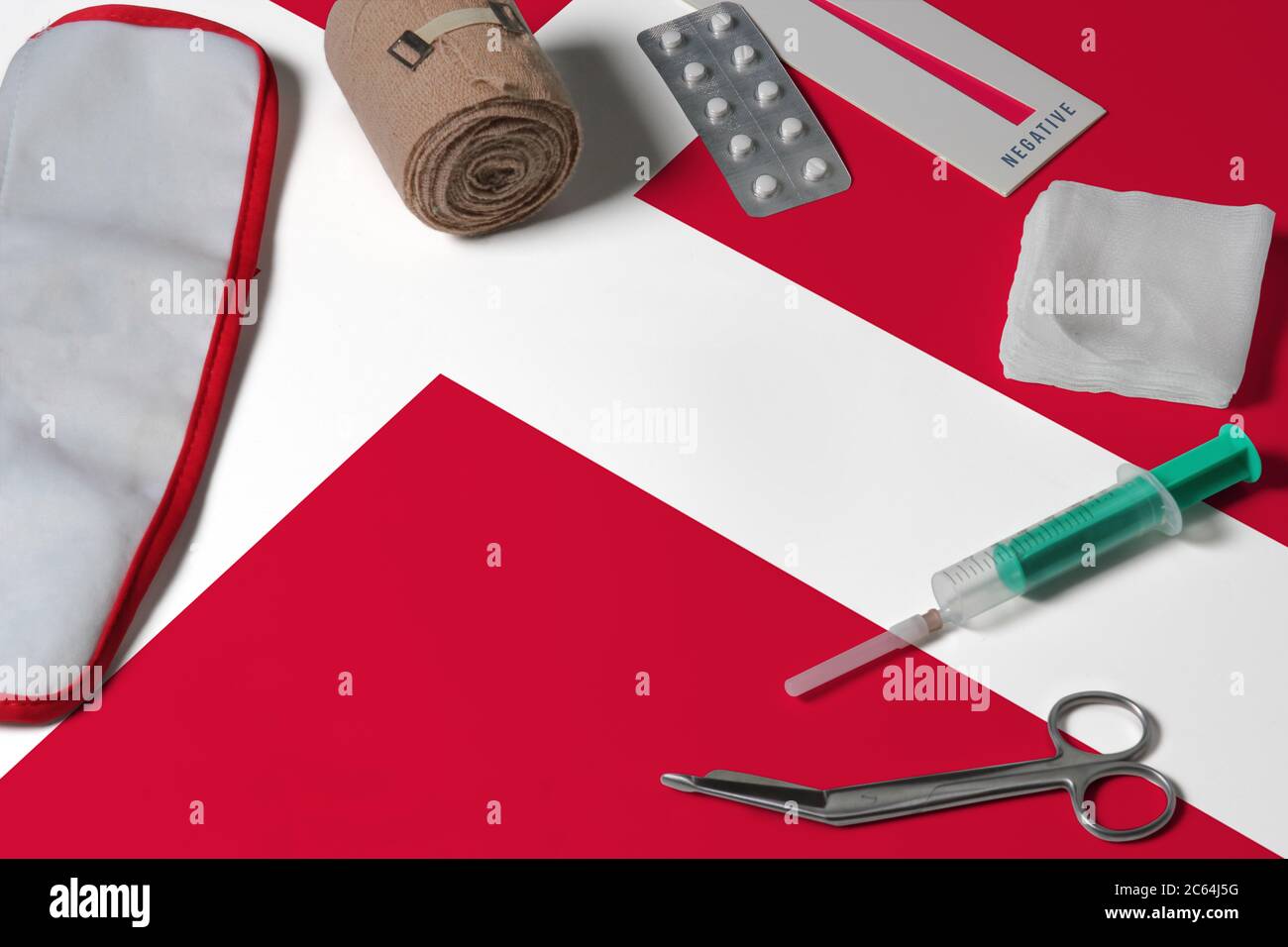 Denmark flag with first aid medical kit on wooden table background ...