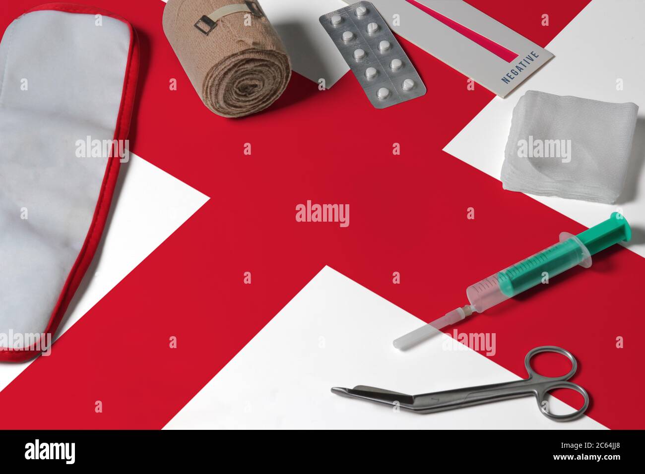 England flag with first aid medical kit on wooden table background ...
