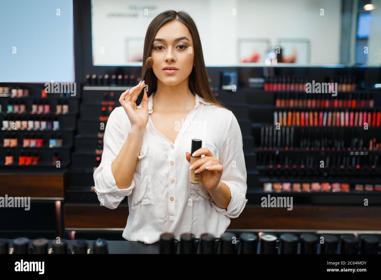 Beautiful woman in cosmetics store, front view Stock Photo - Alamy
