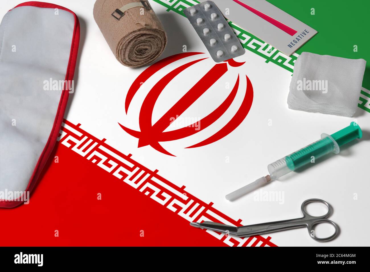 Iran flag with first aid medical kit on wooden table background ...