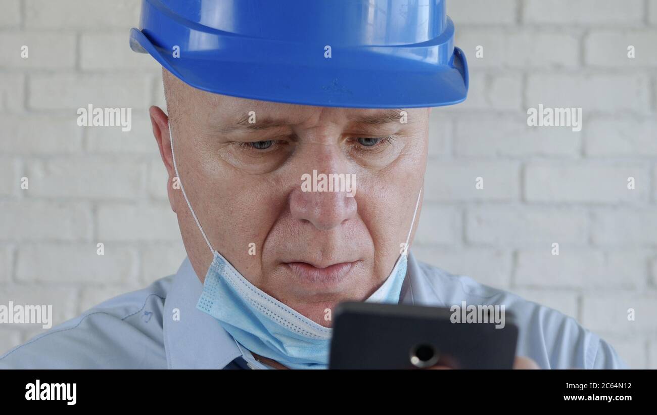 Engineer with Safety Helmet and a Protection Mask on His Face Talking ...