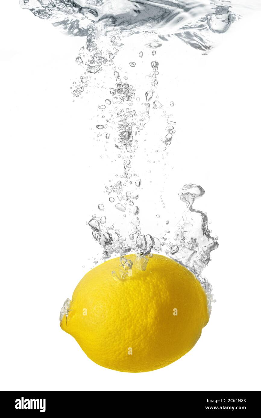 lemon dropped into water isolated on white Stock Photo - Alamy