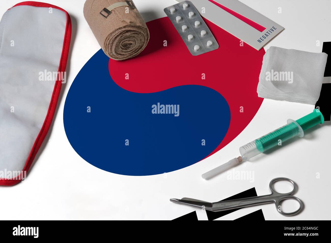 South Korea flag with first aid medical kit on wooden table background ...