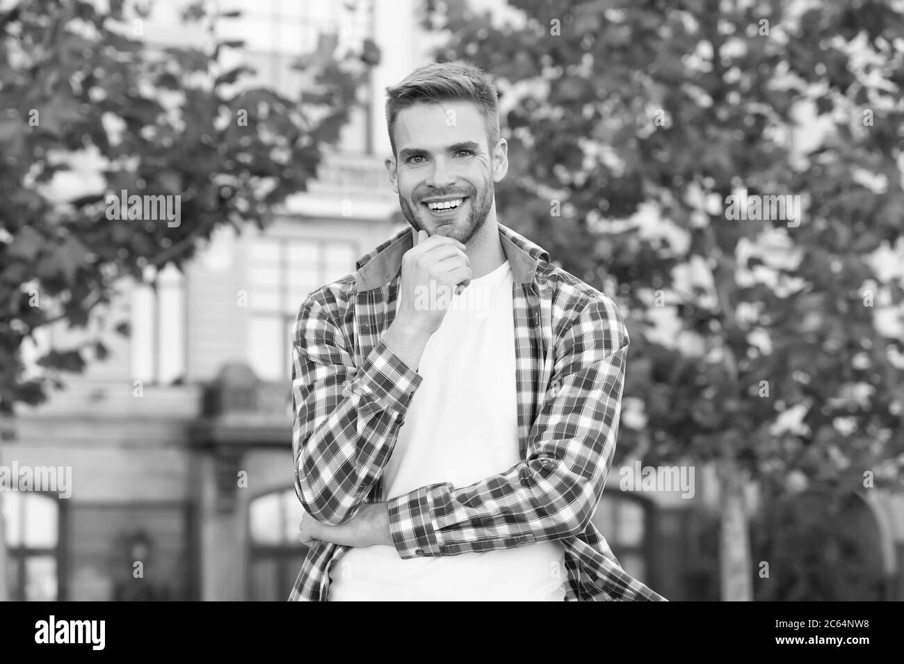 Cool about being scruffy. Unshaven guy smile urban outdoor. Happy man ...