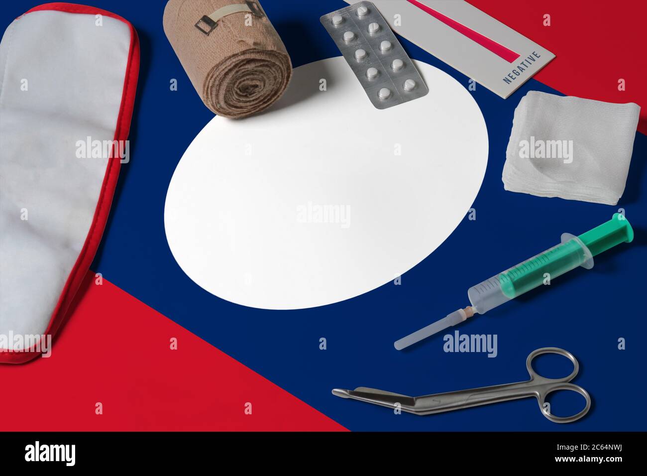 Laos flag with first aid medical kit on wooden table background ...