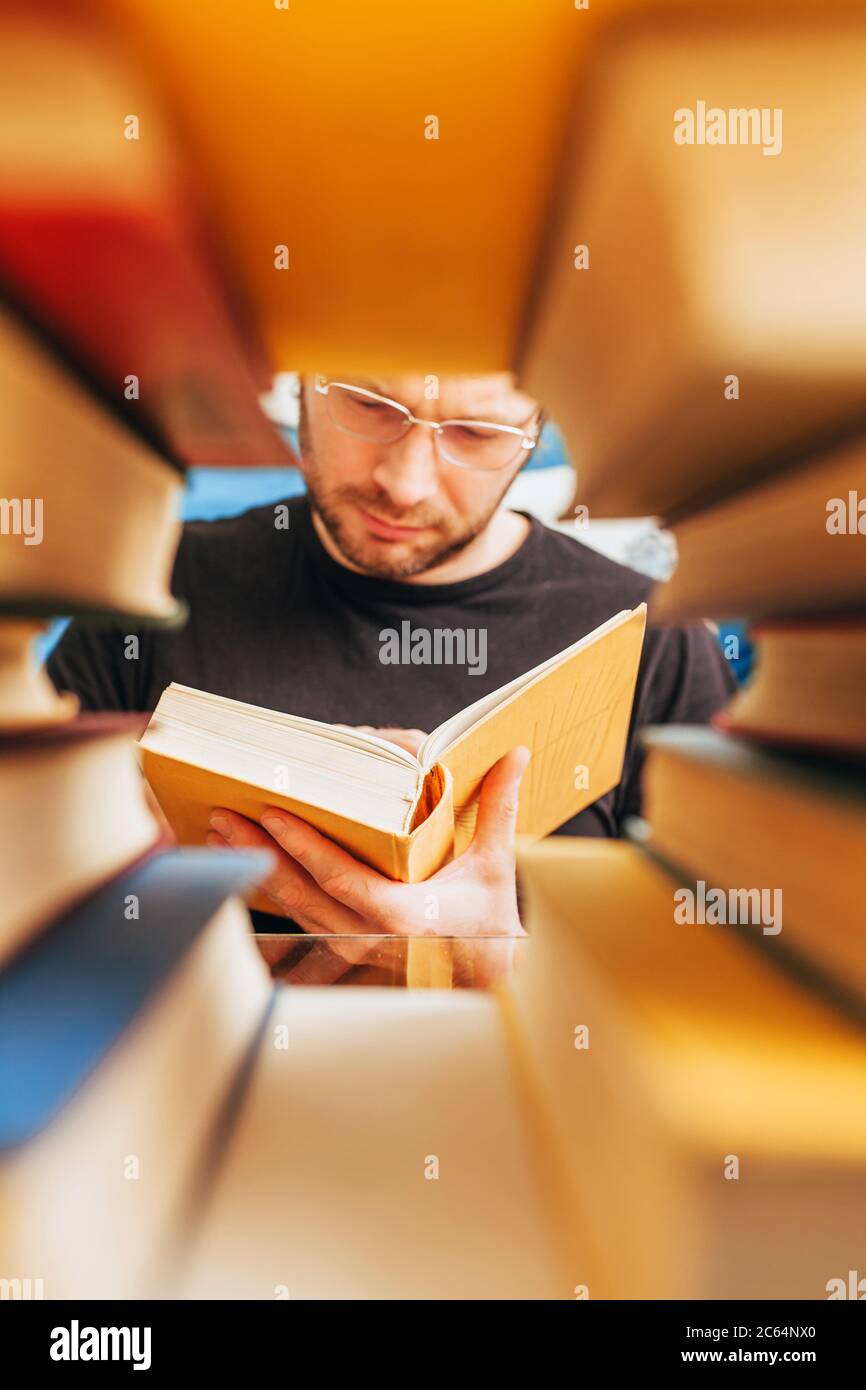 Male teacher pile books hi-res stock photography and images - Alamy