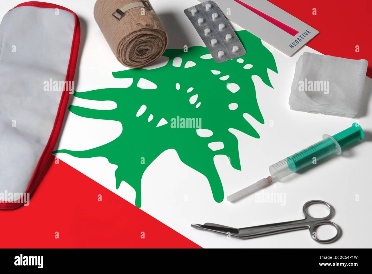 Lebanon flag with first aid medical kit on wooden table background ...