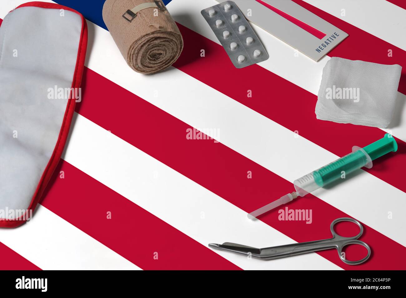 Liberia flag with first aid medical kit on wooden table background ...