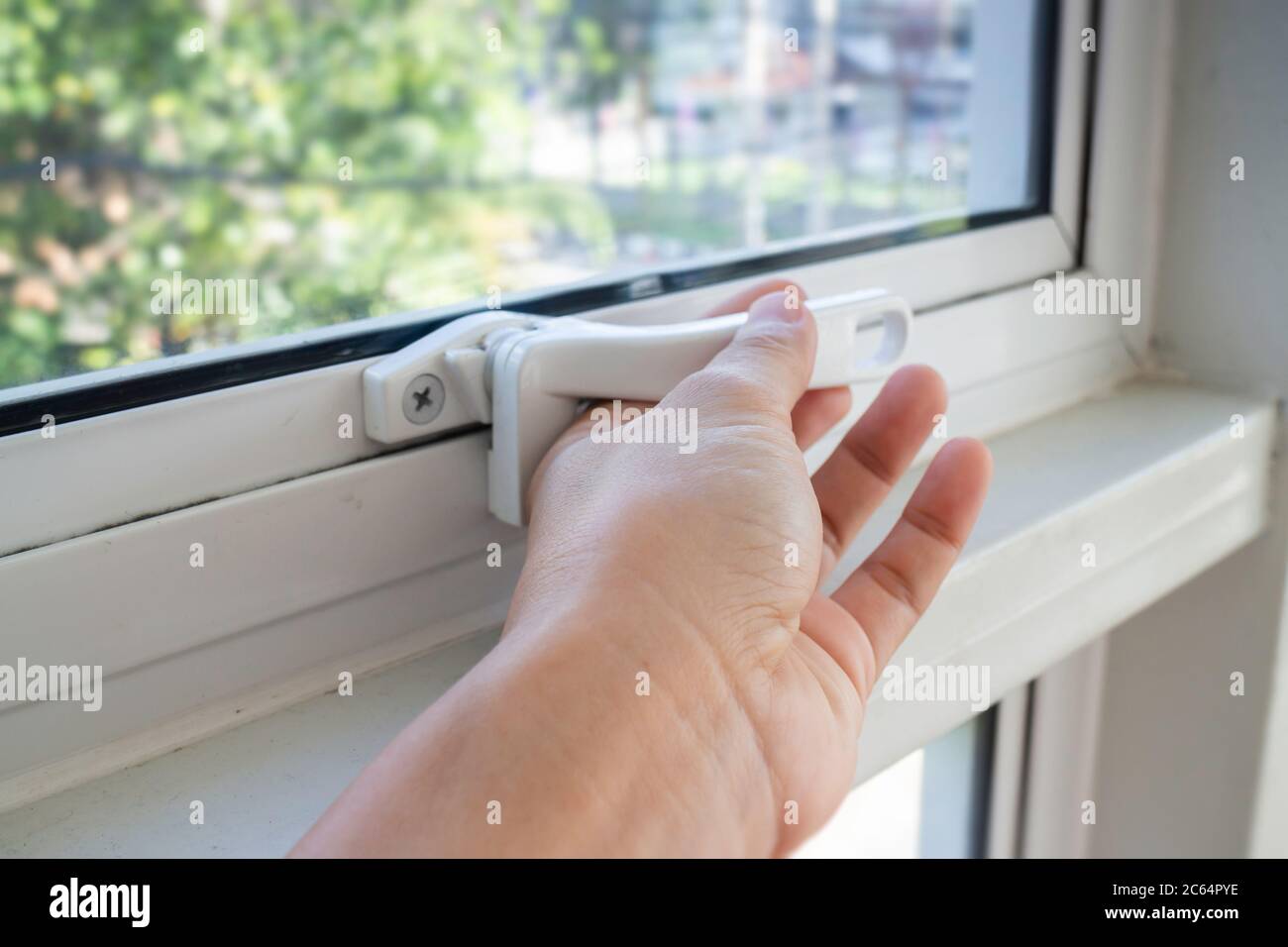 Hand holding glass window latch lever, stock photo Stock Photo - Alamy