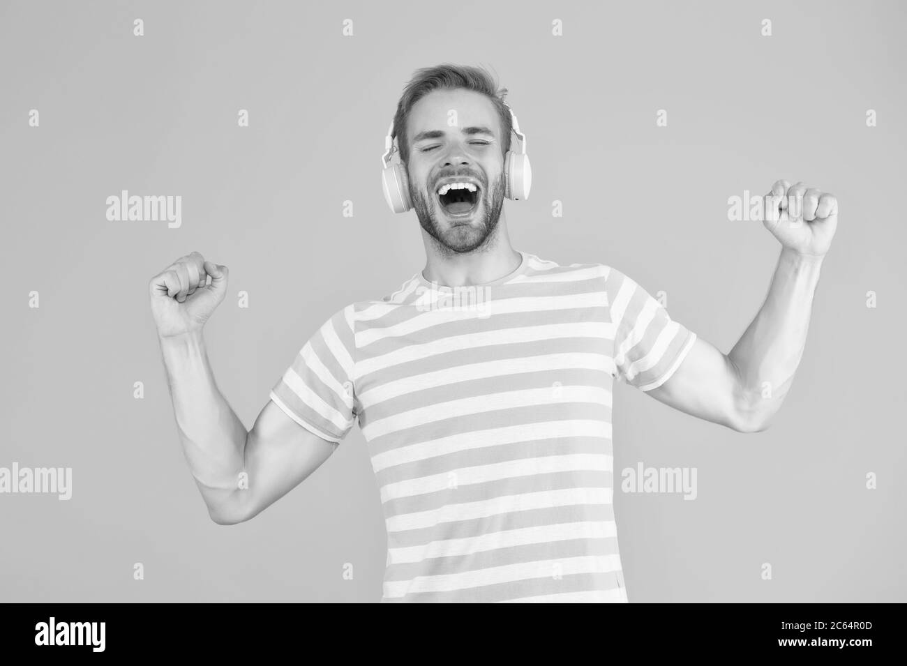 Music makes me happy. Happy man listen to music yellow background ...