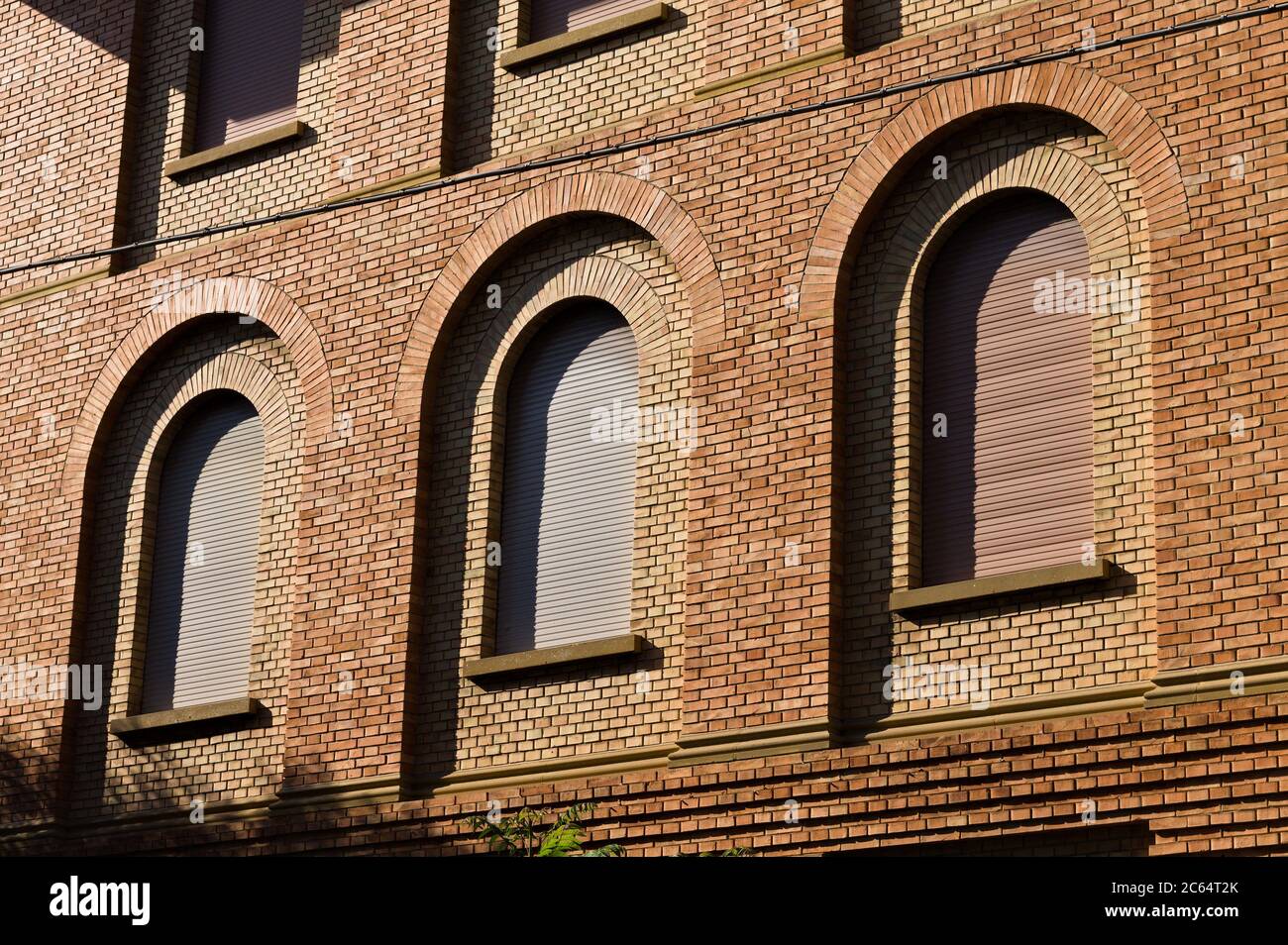 Brick facade with round arches of an old building (Pesaro, Italy ...