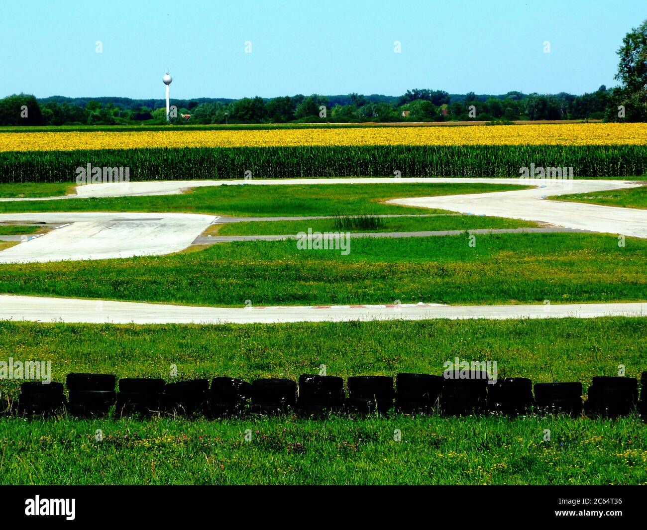 empty gocart race track in the summer with road bends and rubber tires ...