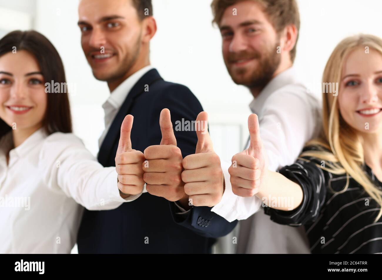 Beautiful smiling business people showing Ok signs Stock Photo - Alamy