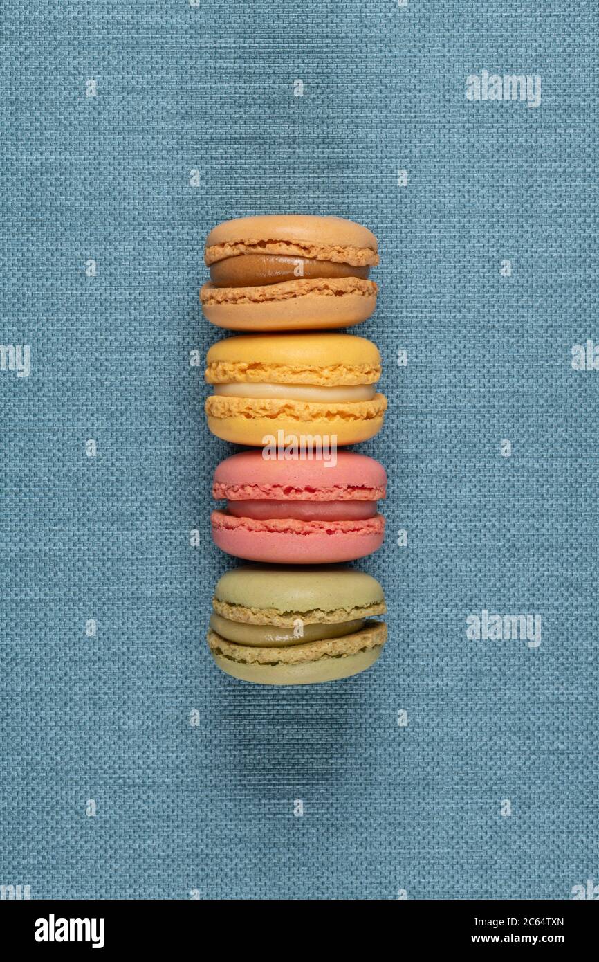 Four macaroonson blue vinyl background Stock Photo - Alamy