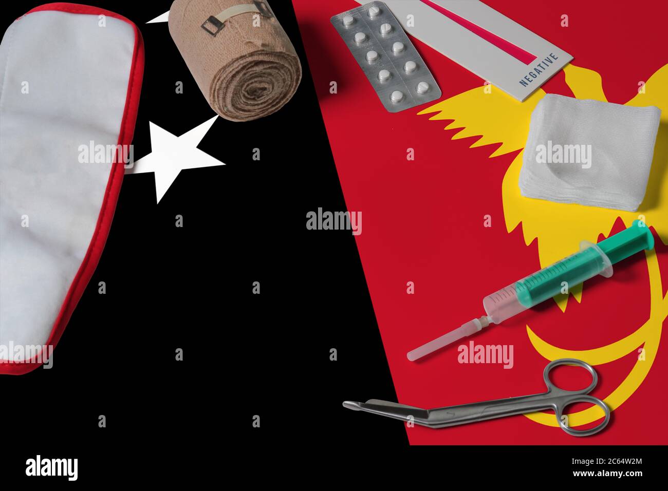 Papua New Guinea flag with first aid medical kit on wooden table ...