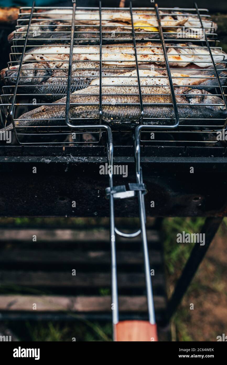 Person frying fish on grill hi-res stock photography and images - Alamy