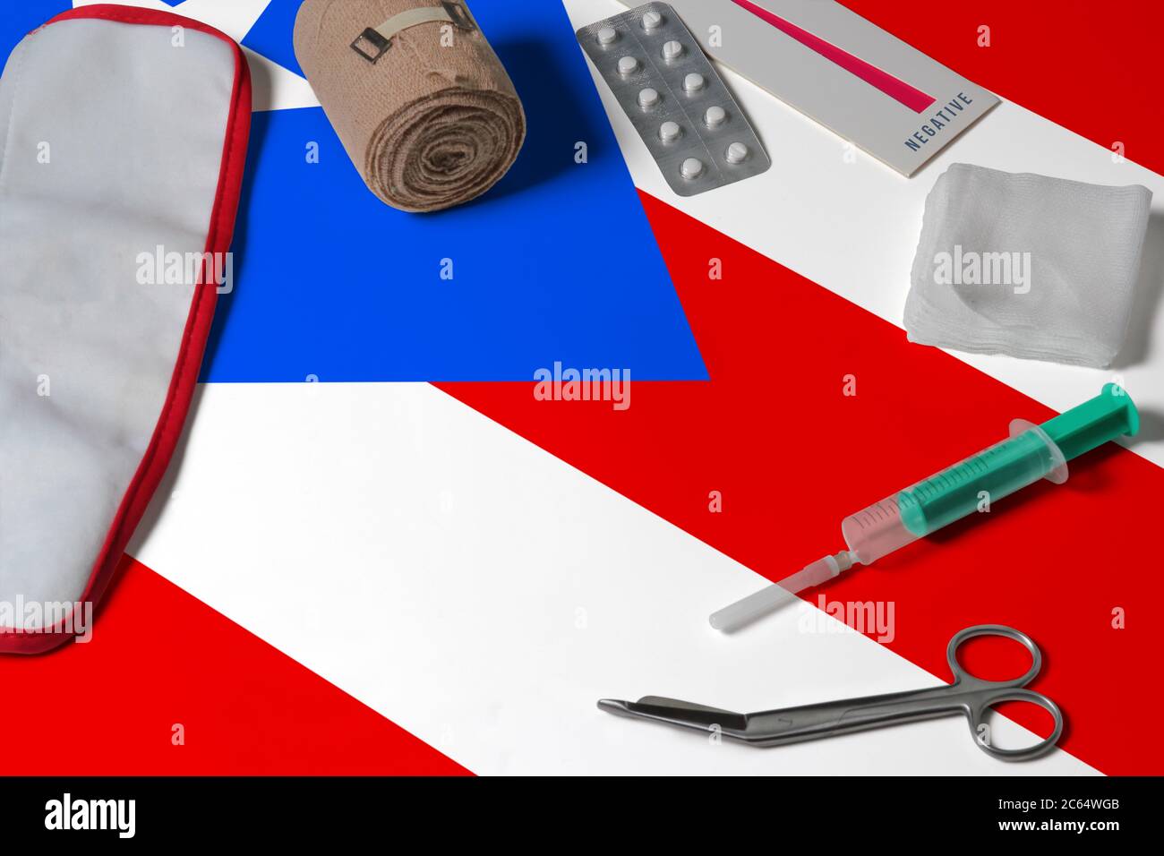 Puerto Rico flag with first aid medical kit on wooden table background ...