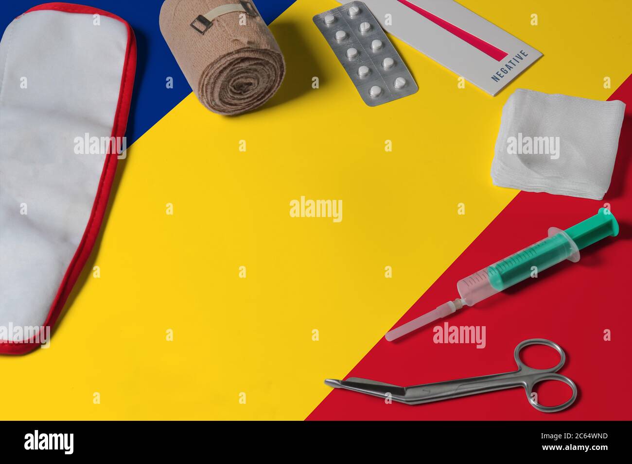 Romania flag with first aid medical kit on wooden table background ...